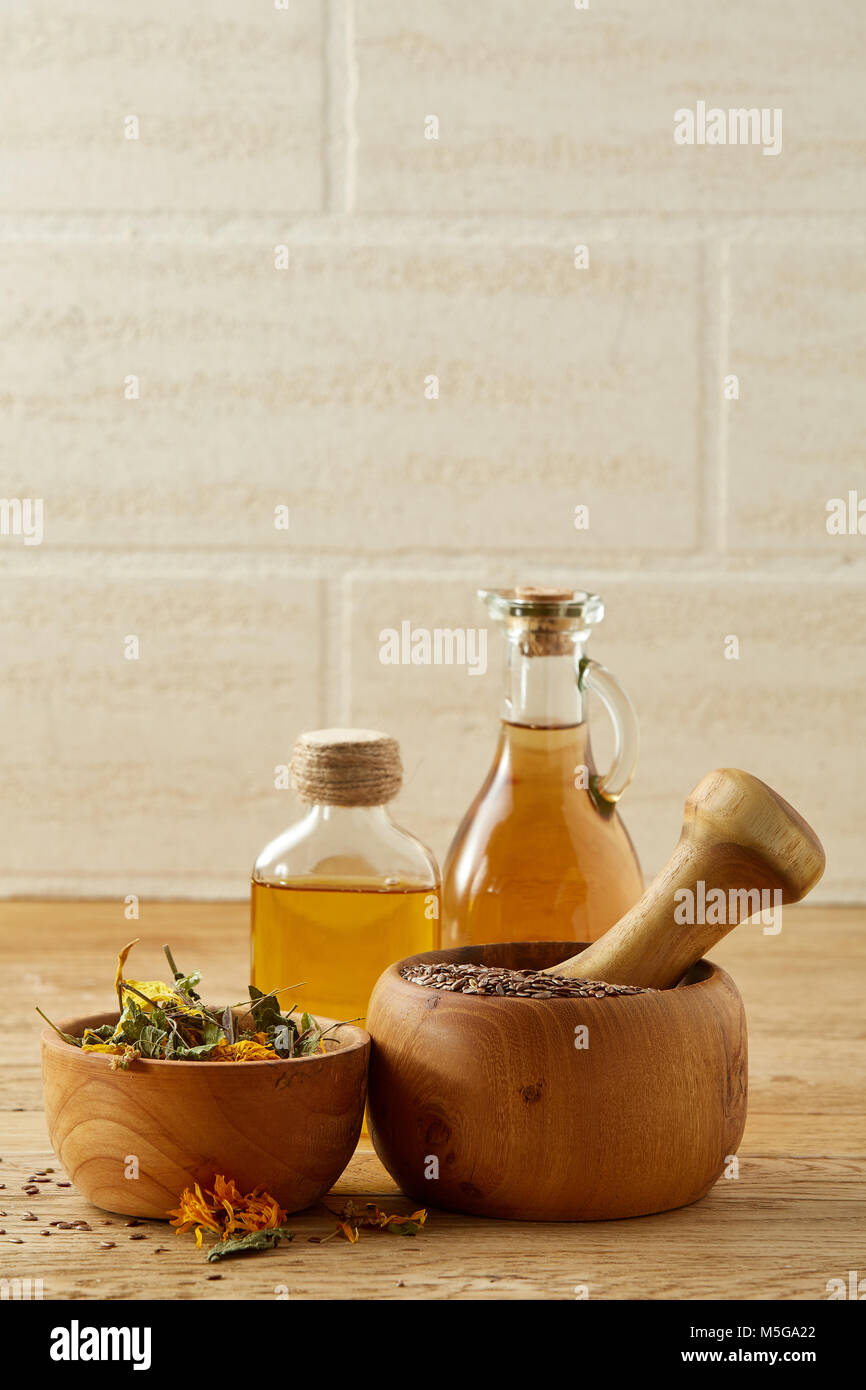 Beautiful still life of two transparent glass oil jars, wooden mortar ...