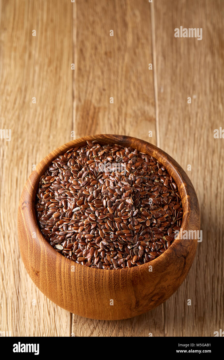 Top view close-up picture of flax seeds in wooden bowl isolated on ...