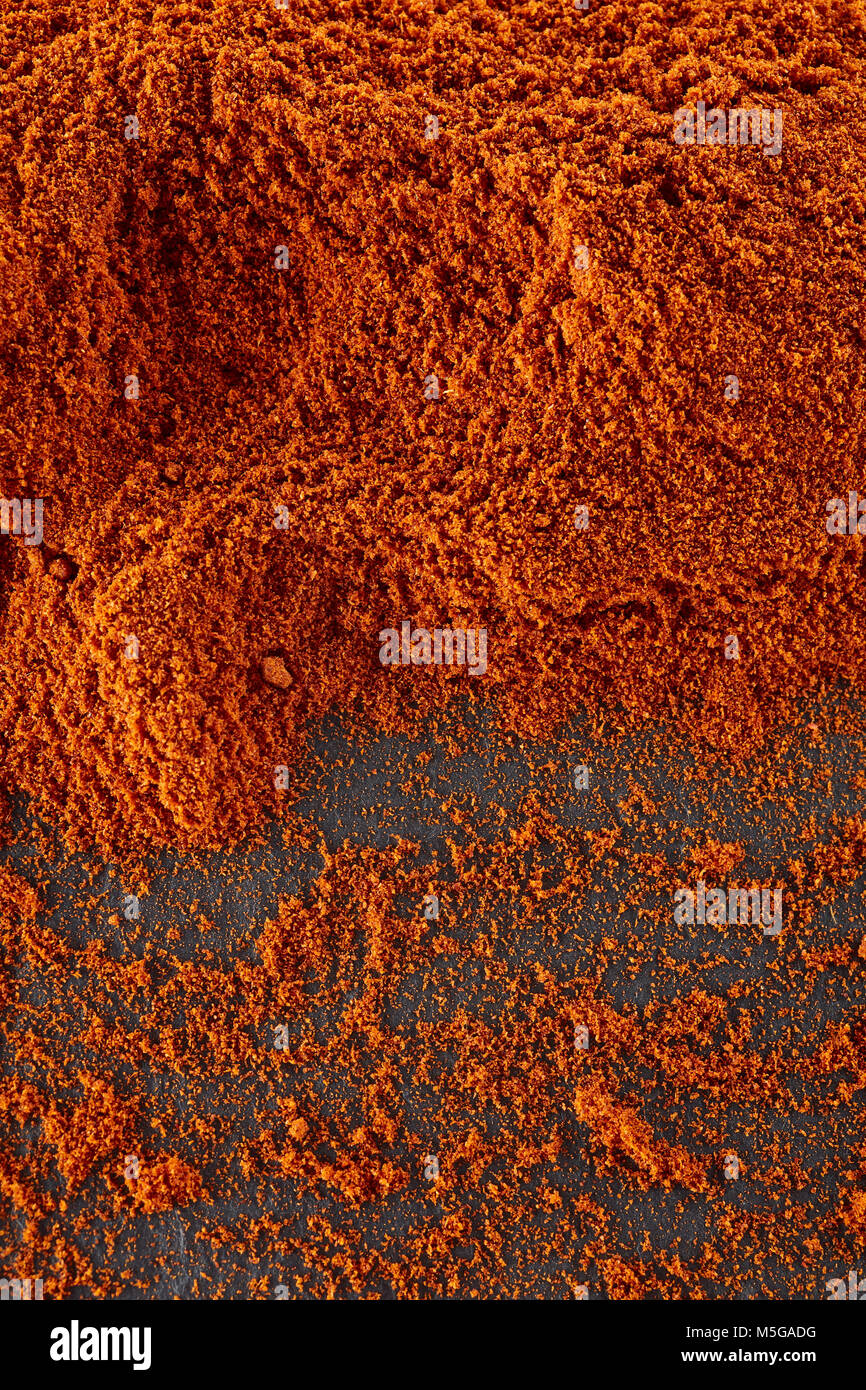 Top view on the texture background of grind paprika or red hot chilli ...