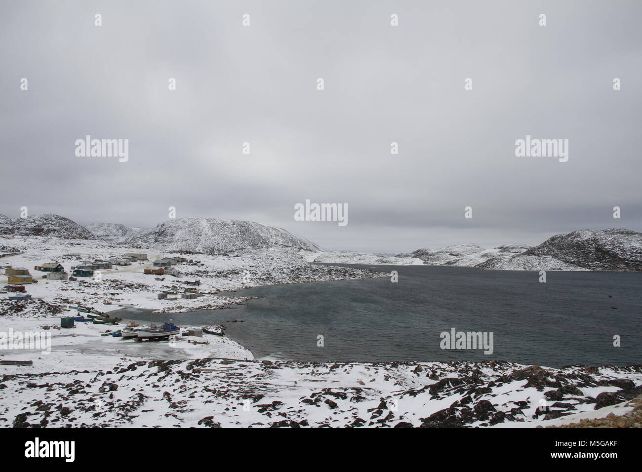 View of Cape Dorset (Kinngait) Nunavut with a view of the mountains and ...