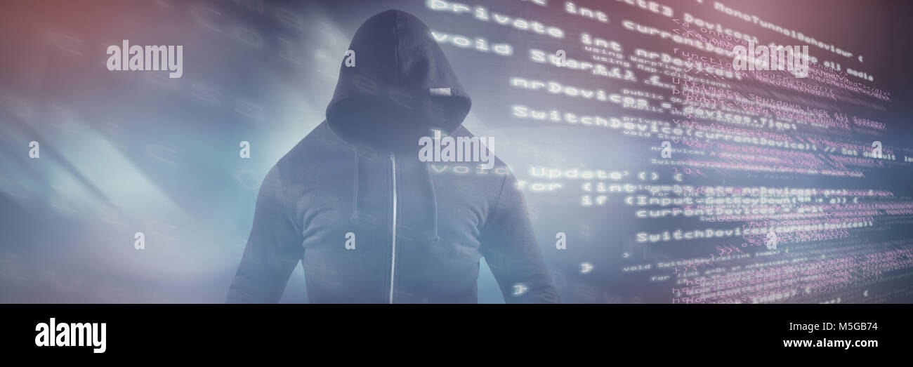 Composite image of male hacker wearing black hoodie while standing ...