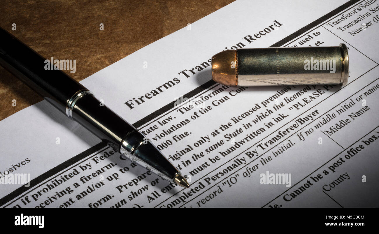 NICS background check form for a gun purchase with a cartridge and pen ...