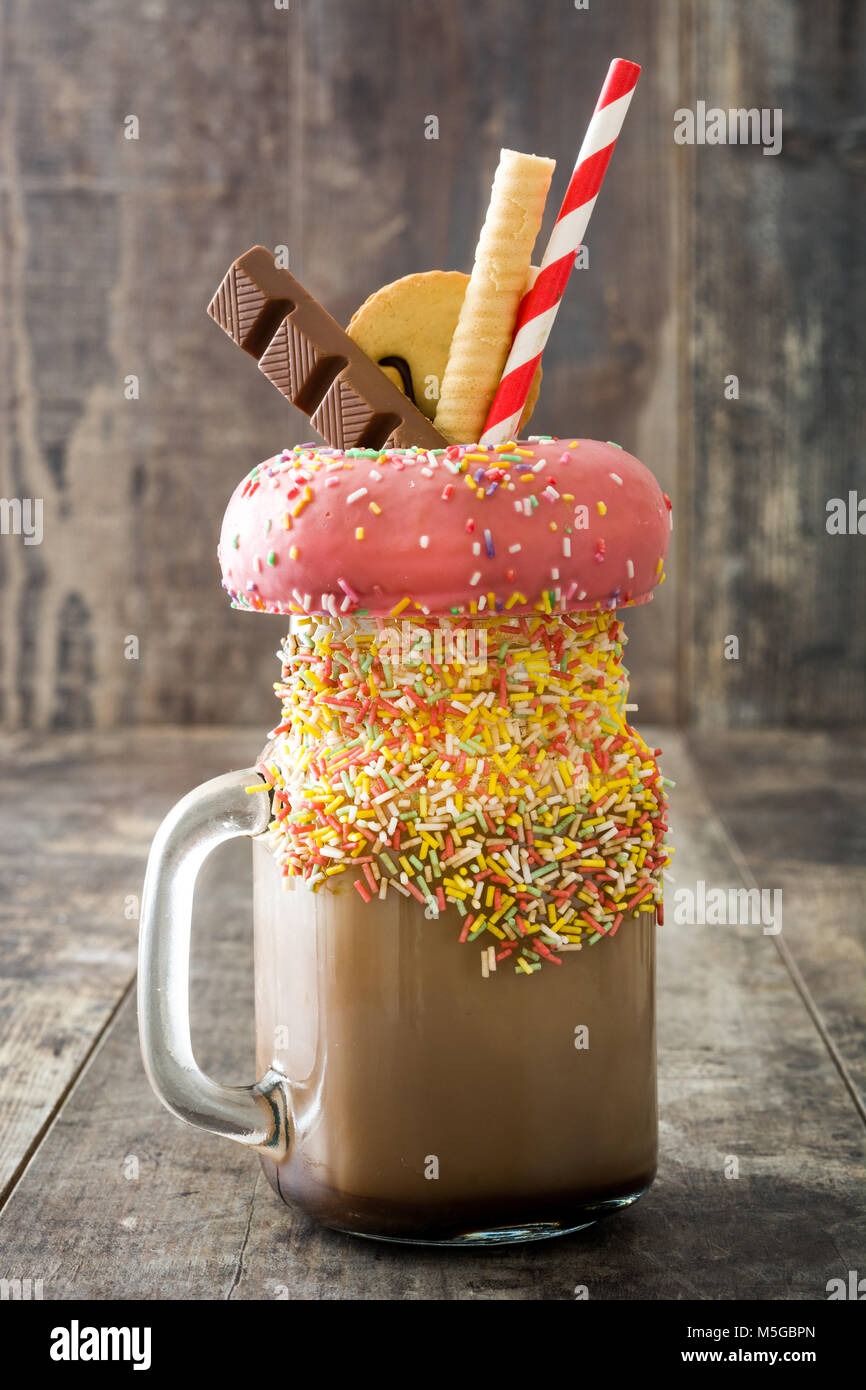 Extreme milkshake or freak shake on wooden table Stock Photo - Alamy