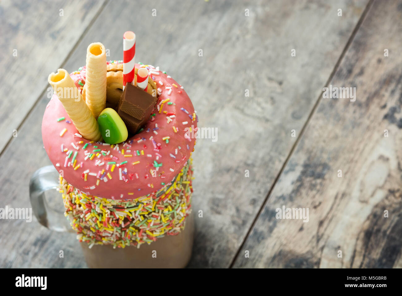 Extreme milkshake or freak shake on wooden table Stock Photo - Alamy