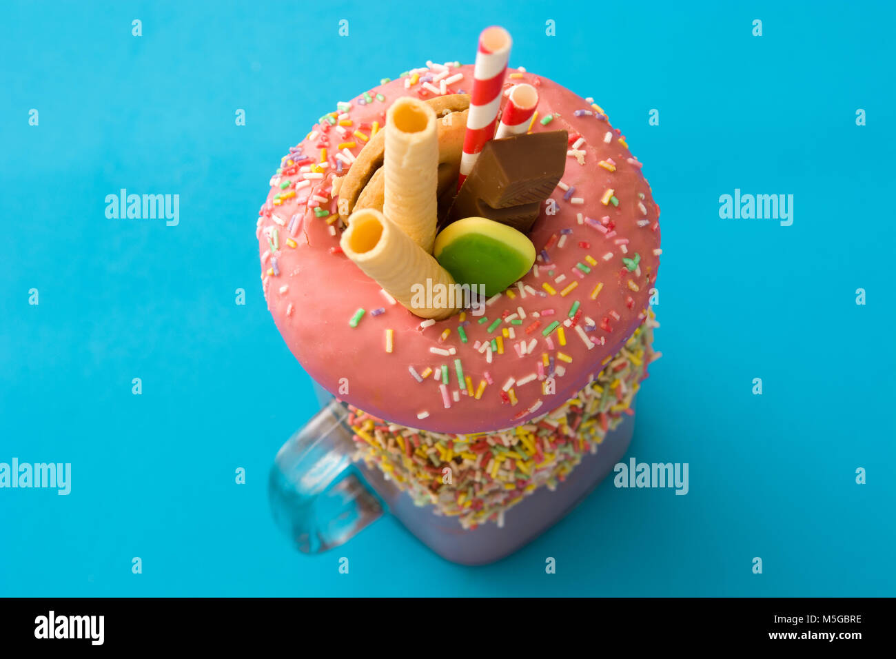 Extreme milkshake or freak shake on blue background Stock Photo - Alamy