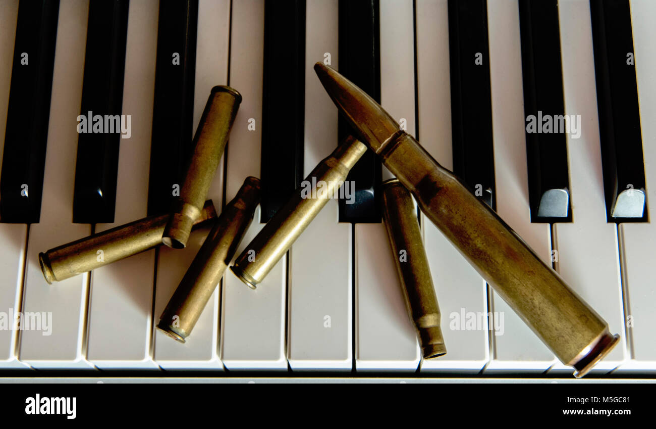 bullet shells on piano keys Stock Photo - Alamy