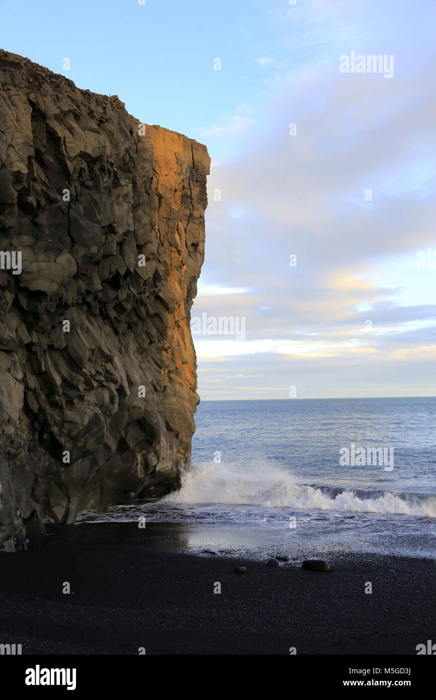 Black sand beach and rock cliff at Kirkjufjara beach near Vik in South ...