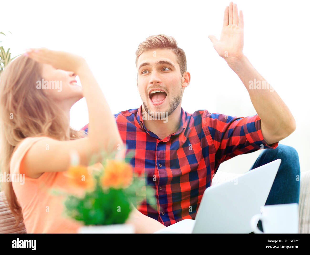 happy young couple giving each other a high five Stock Photo - Alamy