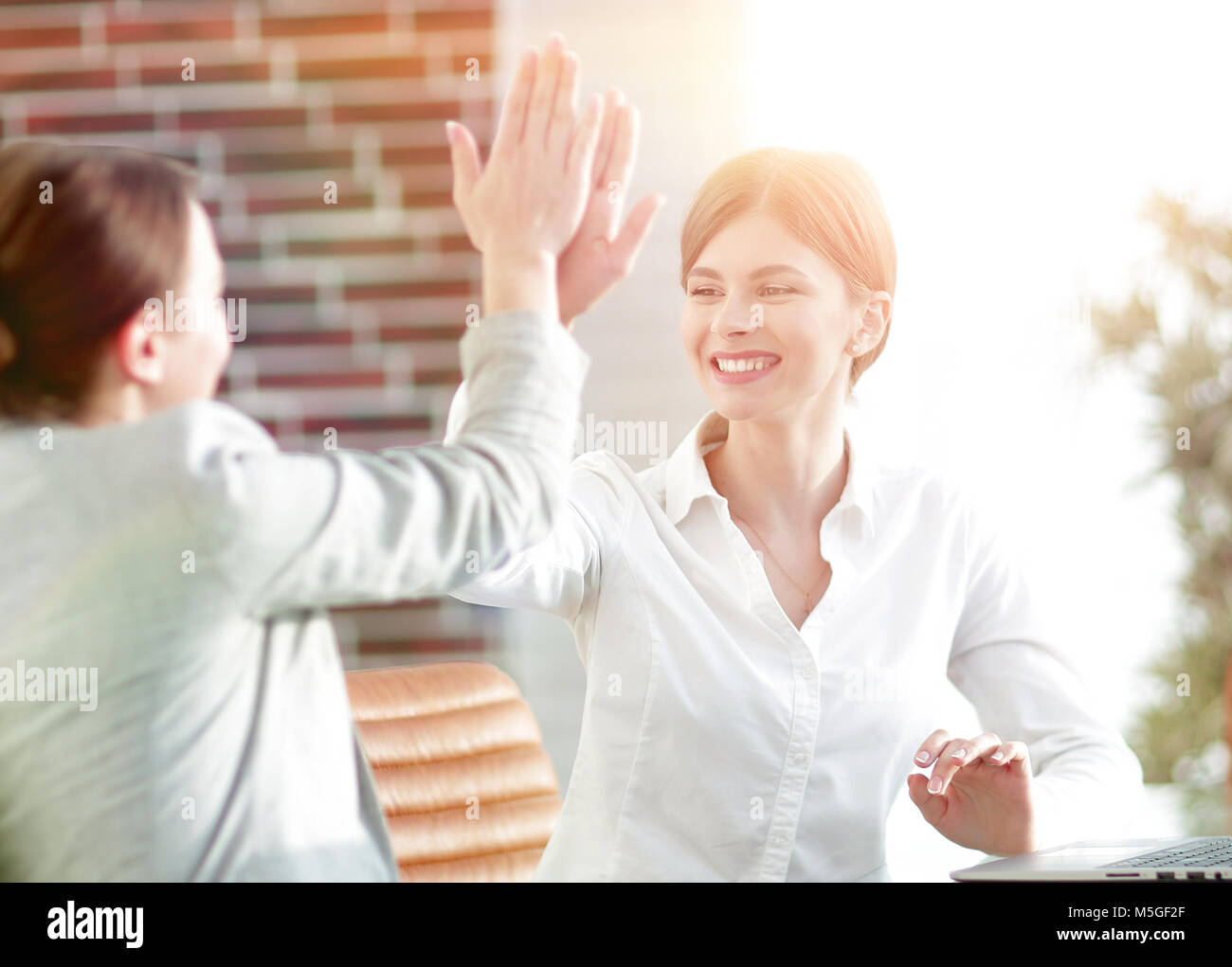 members of the business team giving each other a high five Stock Photo ...