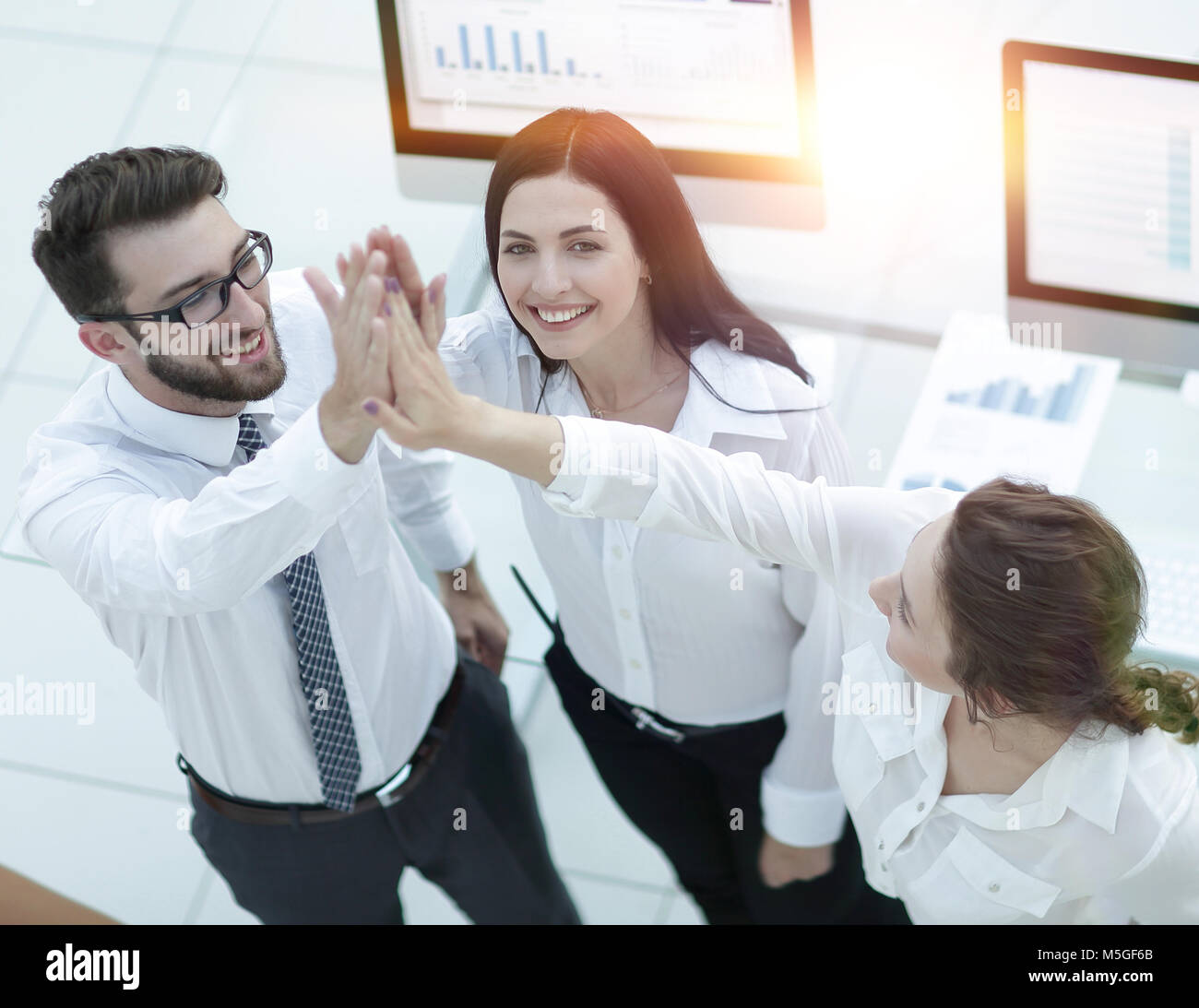 successful business team giving each other a high five Stock Photo - Alamy