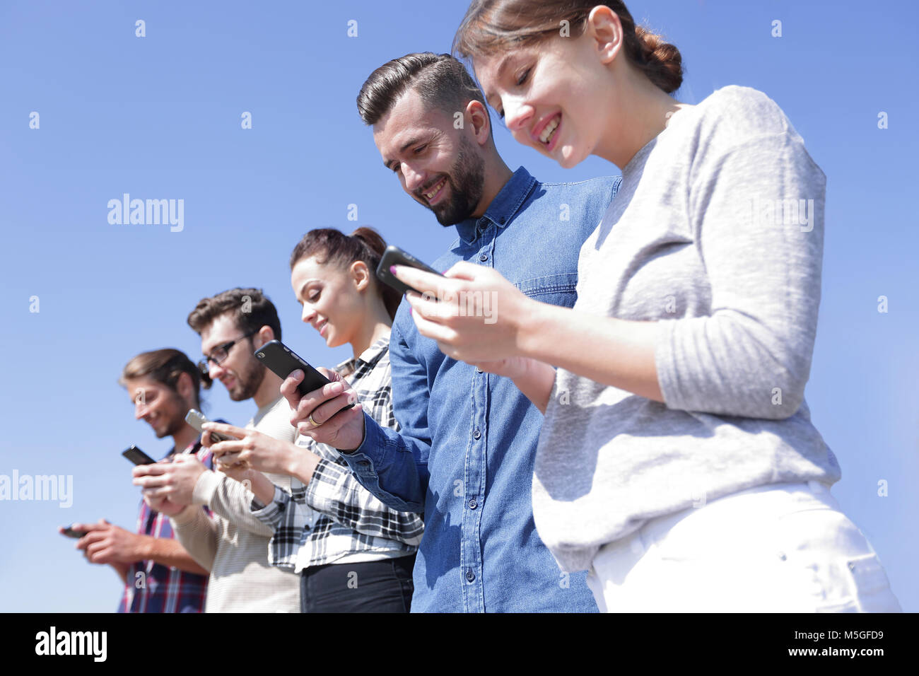 young people using smartphones to search network Stock Photo - Alamy