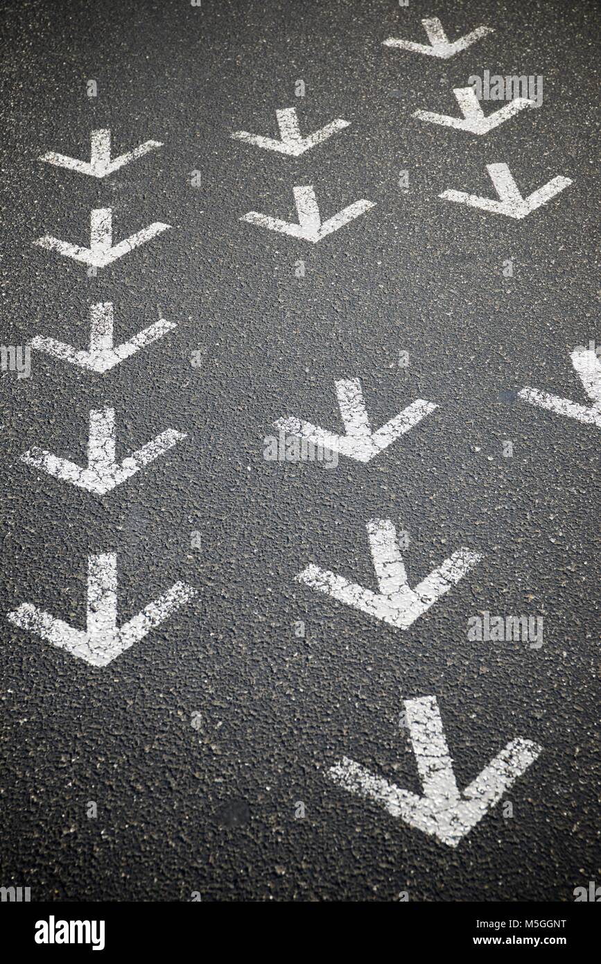 Directional arrows painted on a cement floor Stock Photo - Alamy