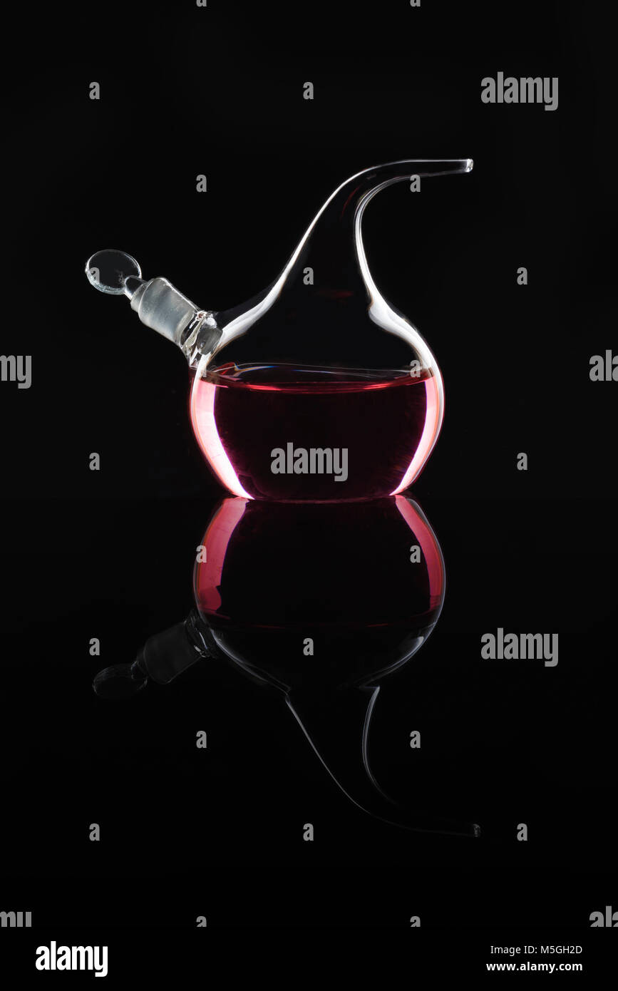 chemical utensils - retort with red liquid on a black background Stock ...