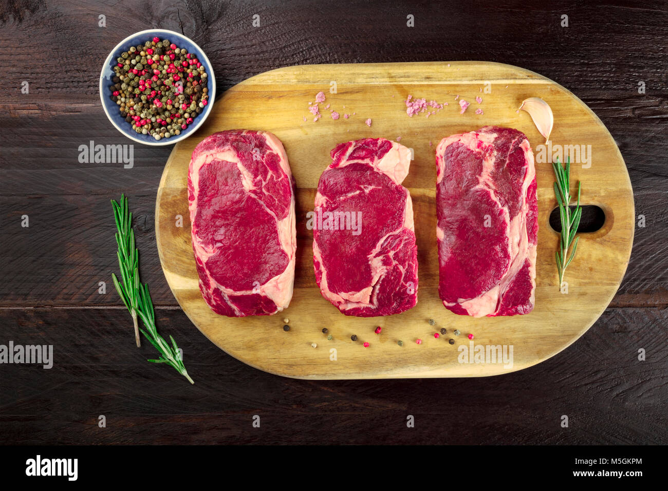 An overhead photo of three slices of raw meat, beef fillet, shot from ...