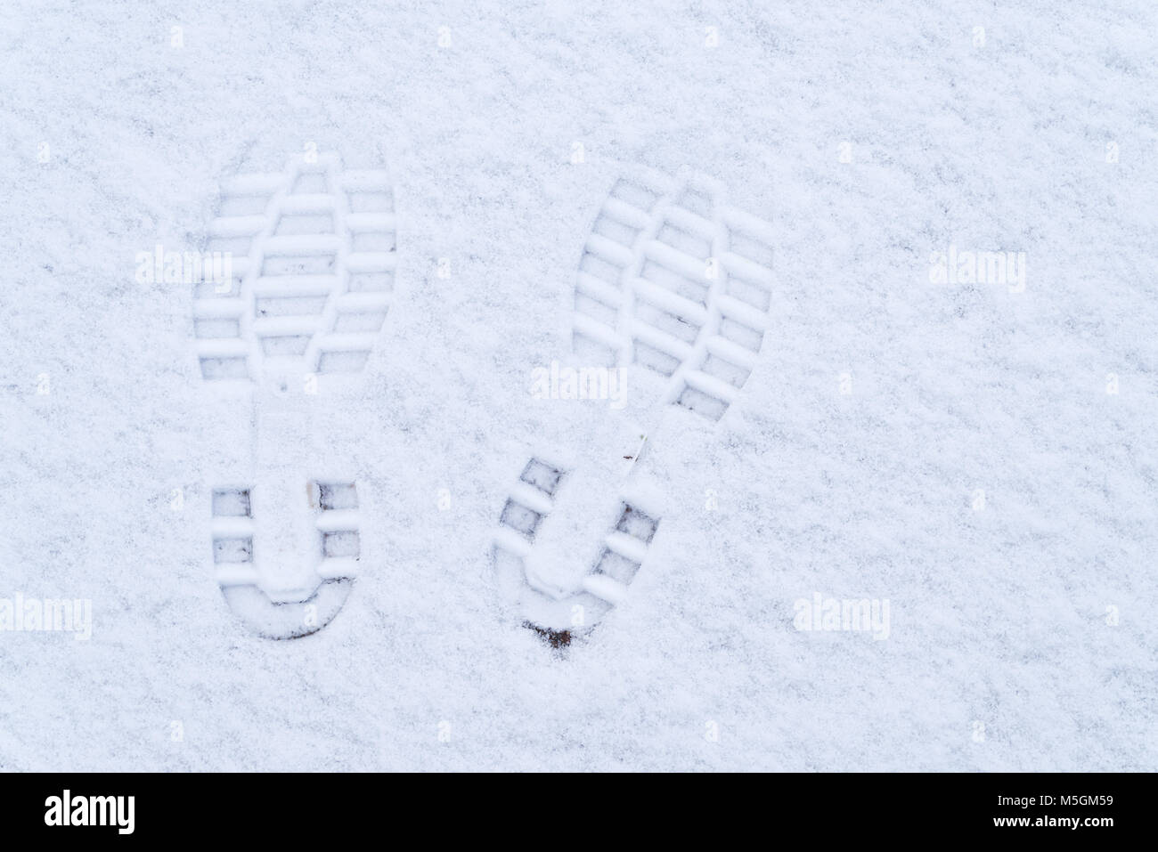 pair of footsteps in the snow Stock Photo - Alamy