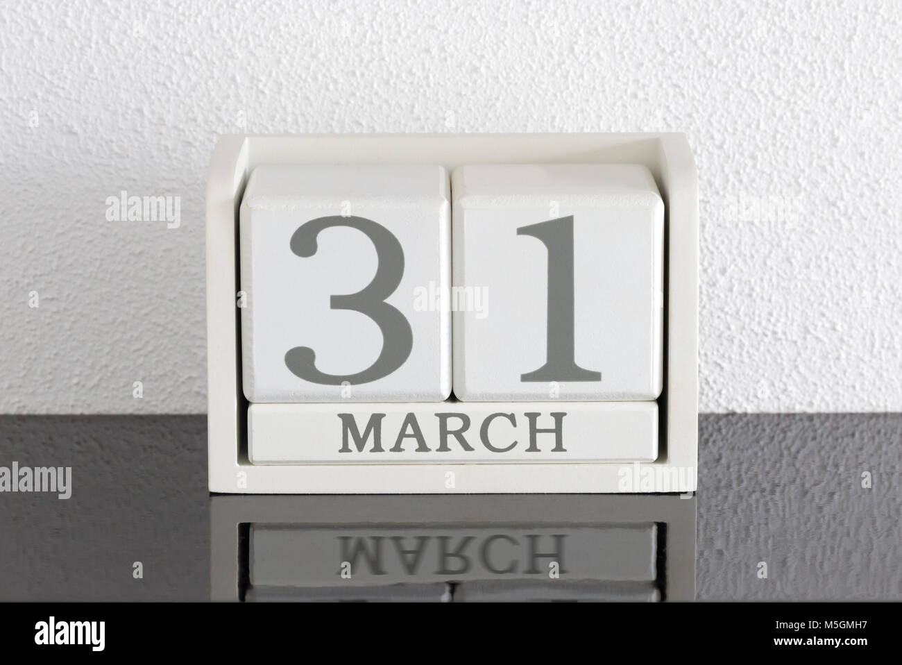 White block calendar present date 31 and month March on white wall ...