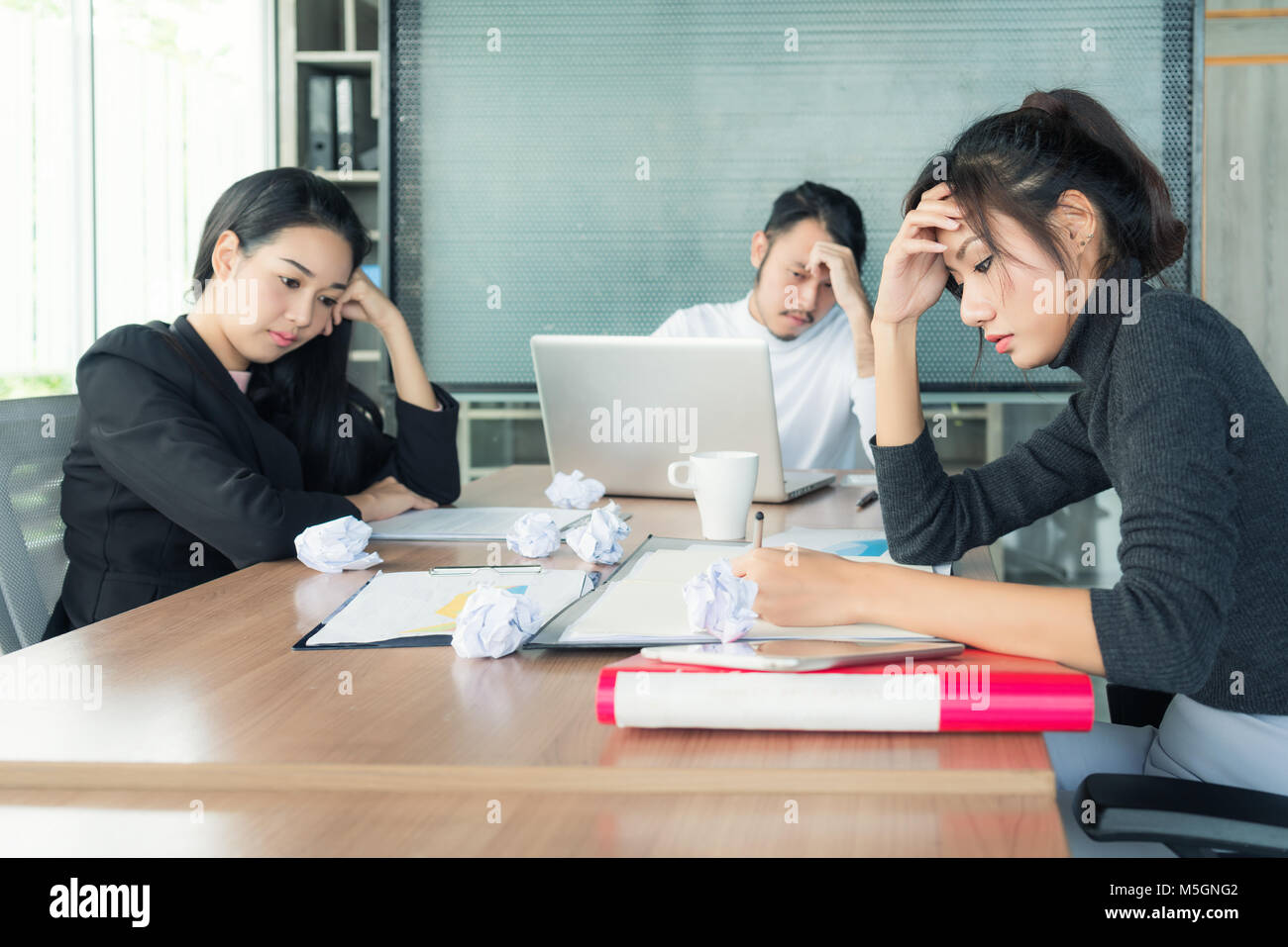 Group of unhappy Asian business people in casual suit sitting in ...