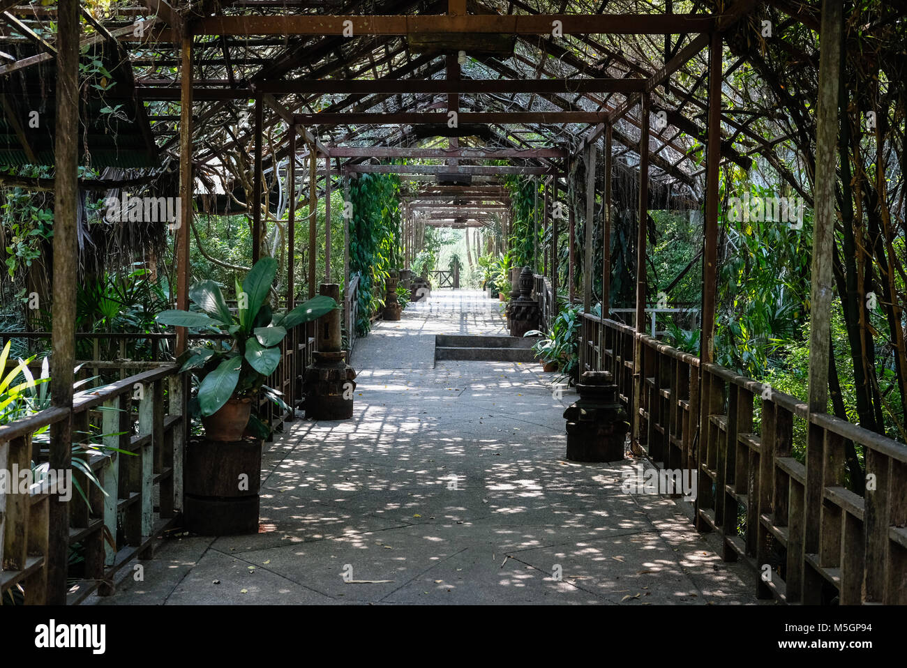 perspective view of walkway in park. pathway in building near garden ...