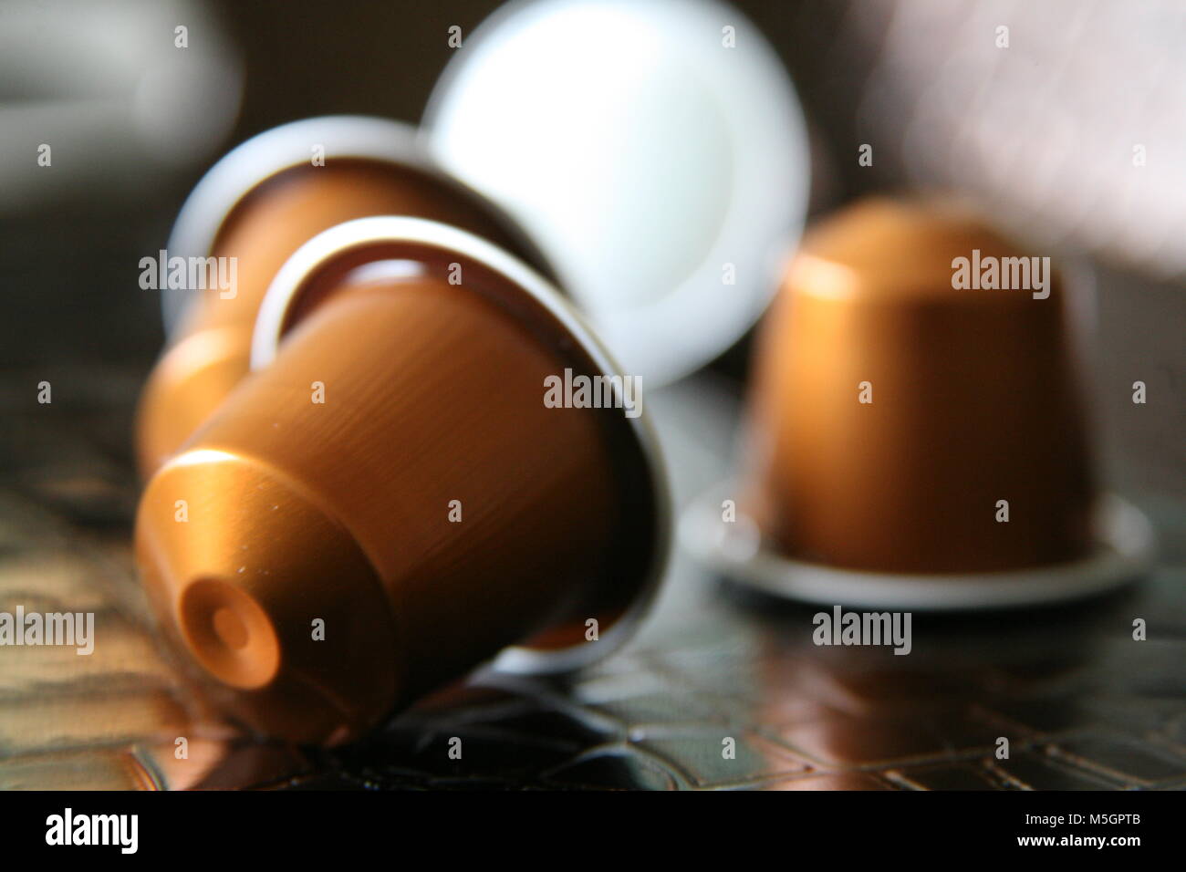 Bronze coffee machine capsules Stock Photo - Alamy