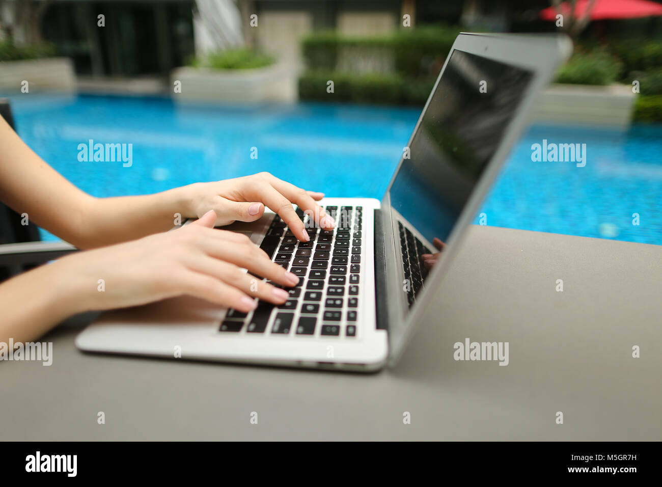 close up woman hands pressing keyboard on laptop sunny day swimm Stock ...