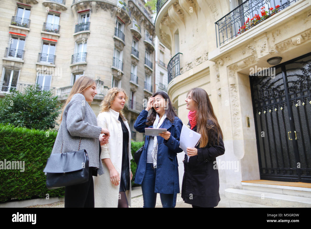 Professor talking with new students near university building in Stock ...