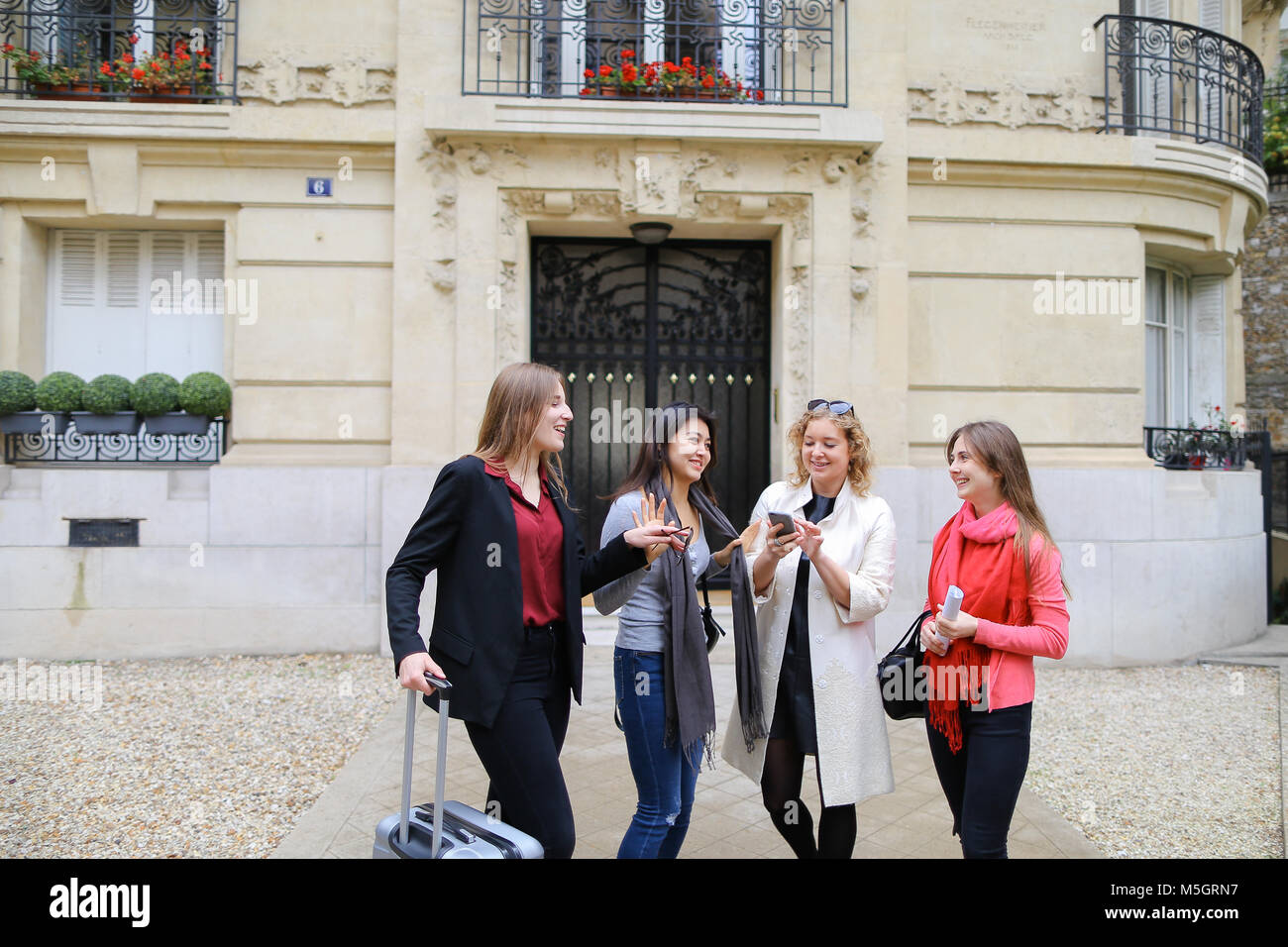 Happy students leaving university building in Stock Photo - Alamy