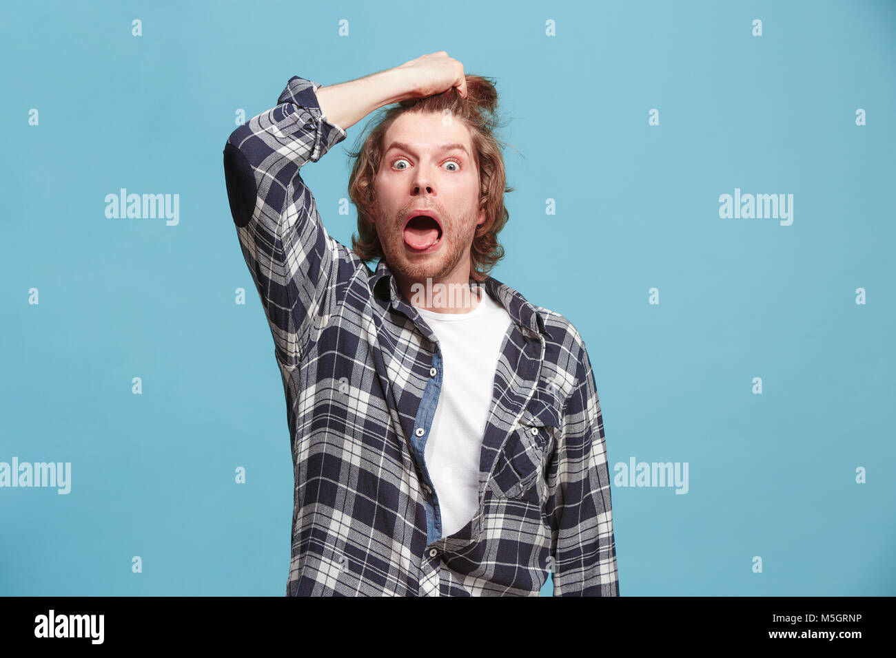 Horrible, stress, shock. male half-length portrait isolated at blue ...