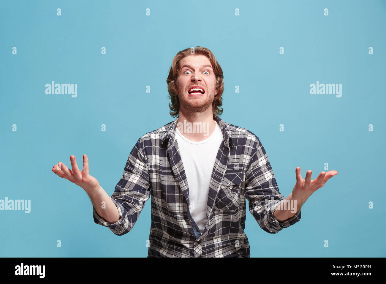 Screaming, hate, rage. Crying emotional angry man screaming on blue ...