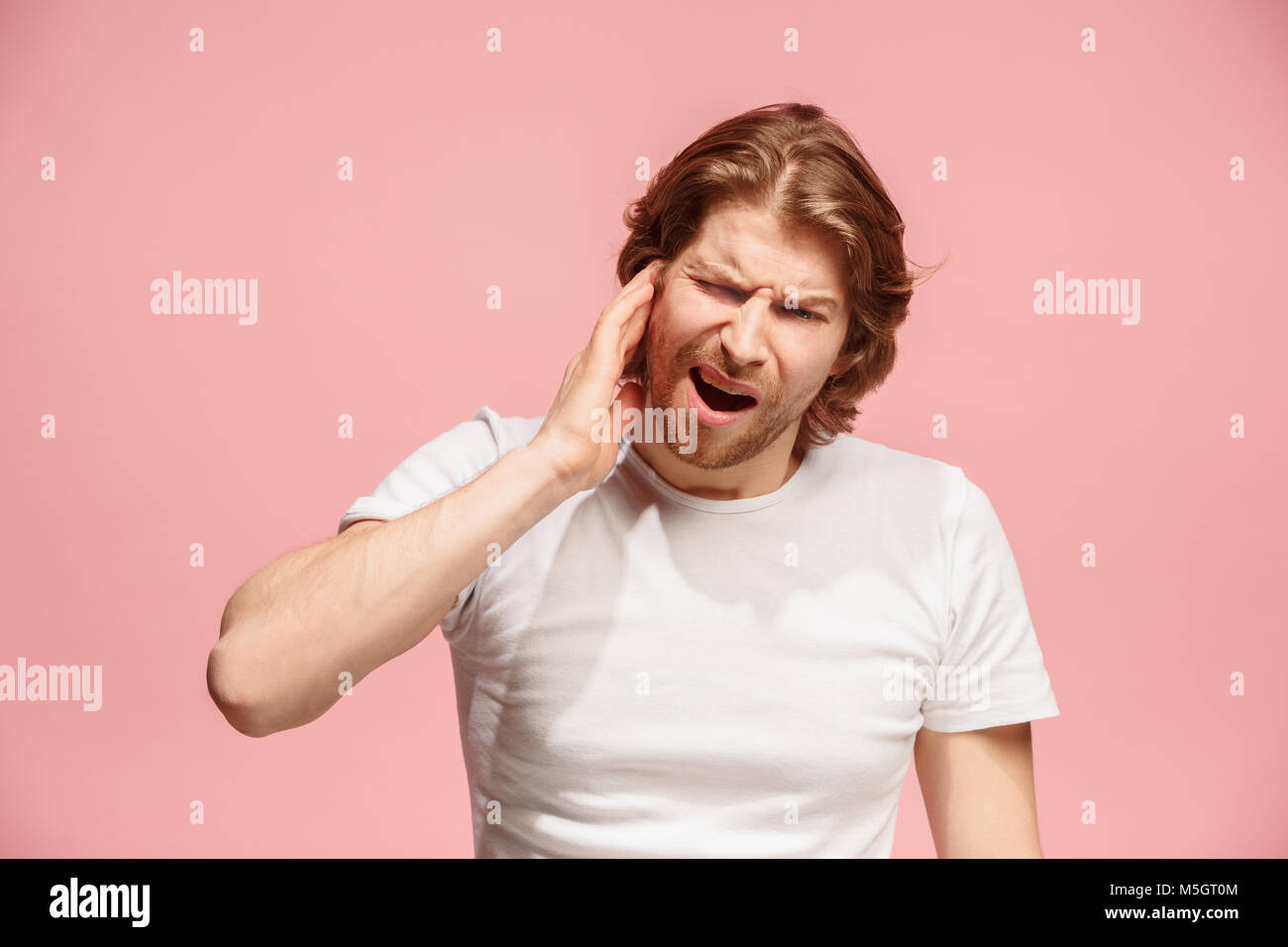 Sore ear. Ear ache concept. The sad crying man with headache or pain on ...