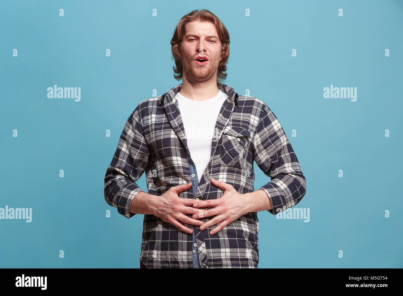 Happy business man standing, smiling isolated on trendy blue studio ...