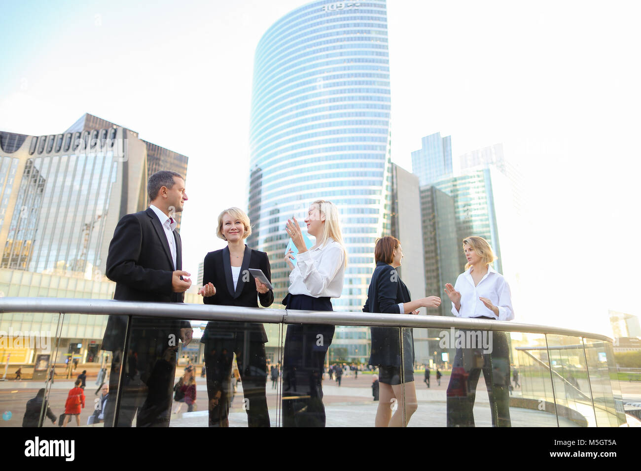 Happy business team members talking outside in Stock Photo - Alamy