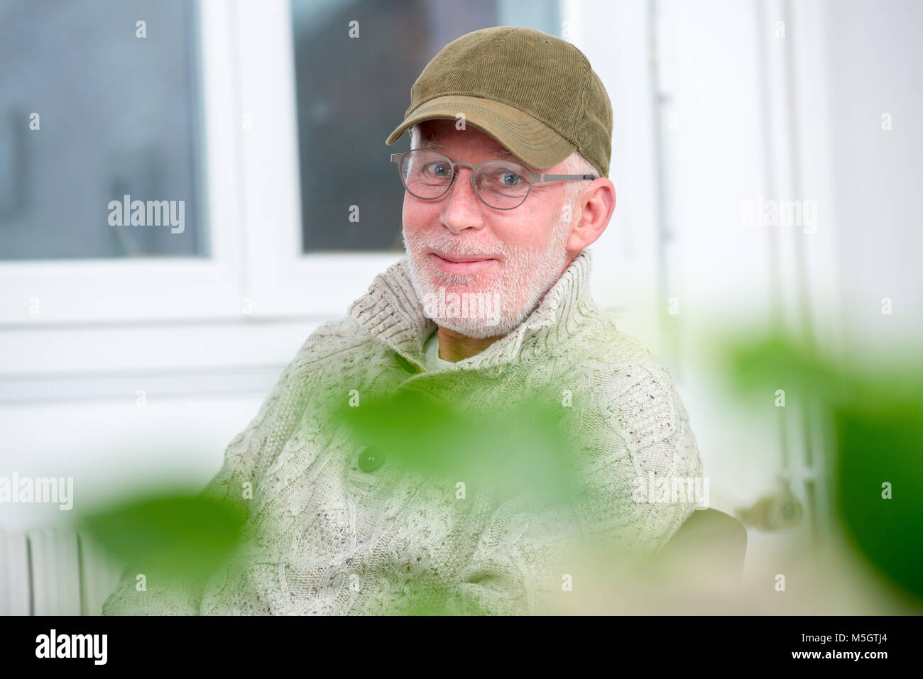 portrait of handsome mature man with a cap Stock Photo - Alamy