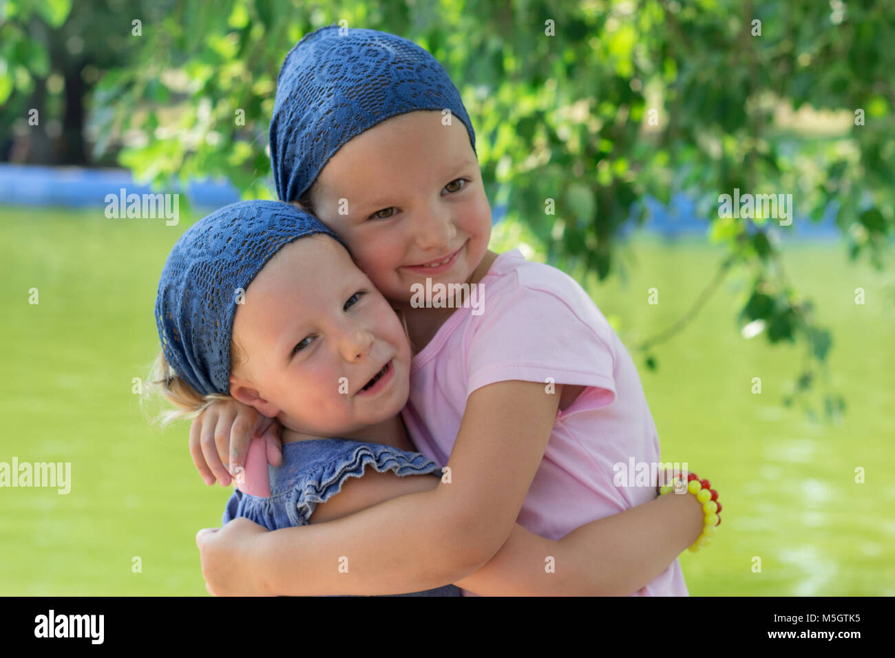 Cute funny little girls (sisters) smile, selective focus Stock Photo ...