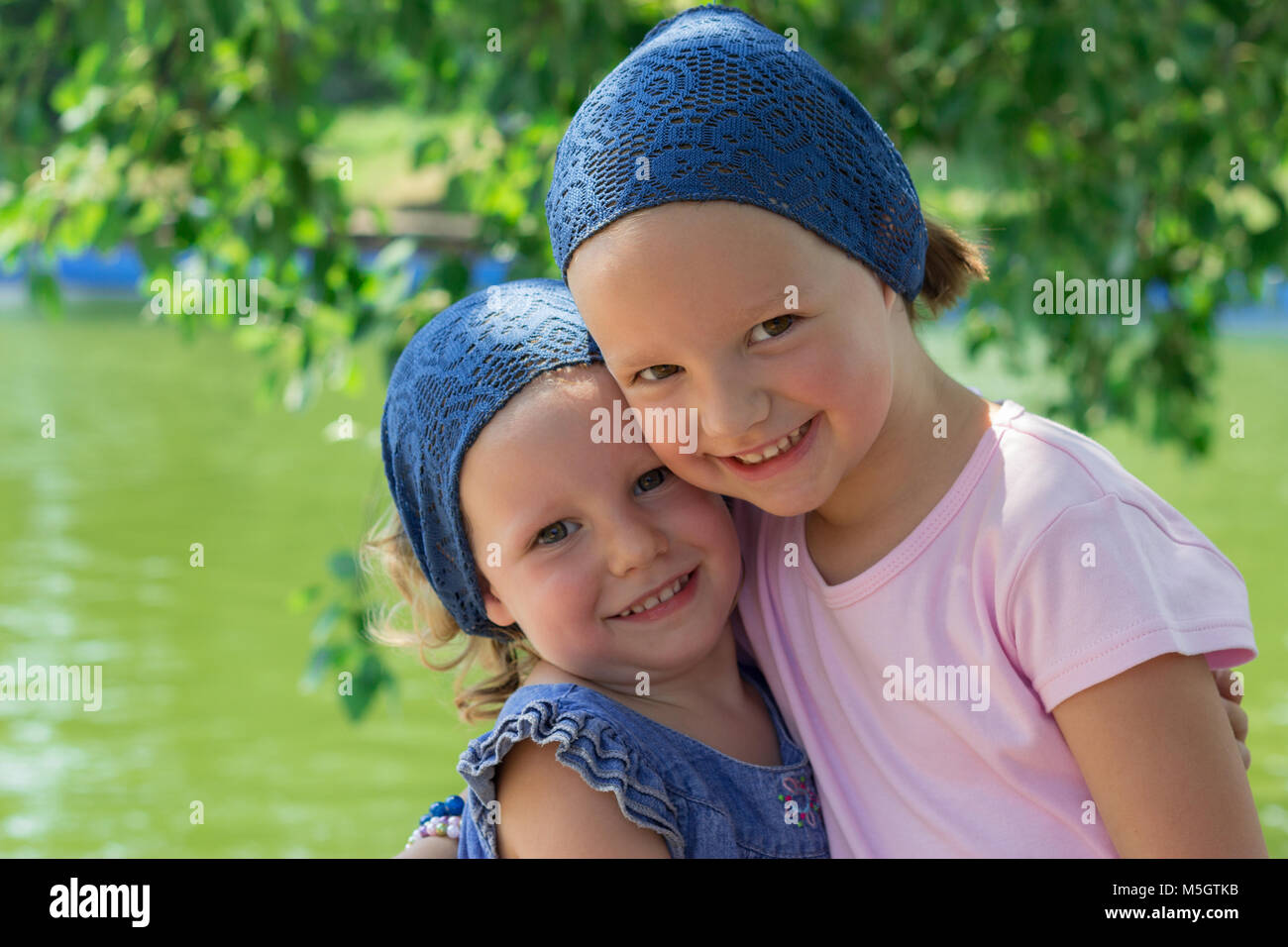 Cute funny little girls (sisters) smile, selective focus Stock Photo ...