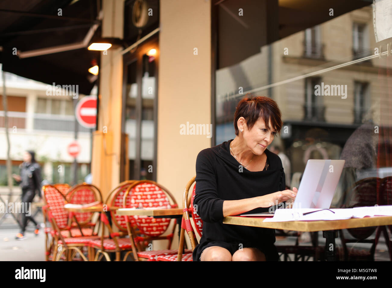 aged female screenwriter working with scenario in laptop Stock Photo ...