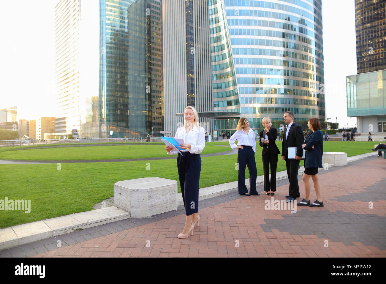Close up face blonde secretary looking at camera and smiling with blue ...
