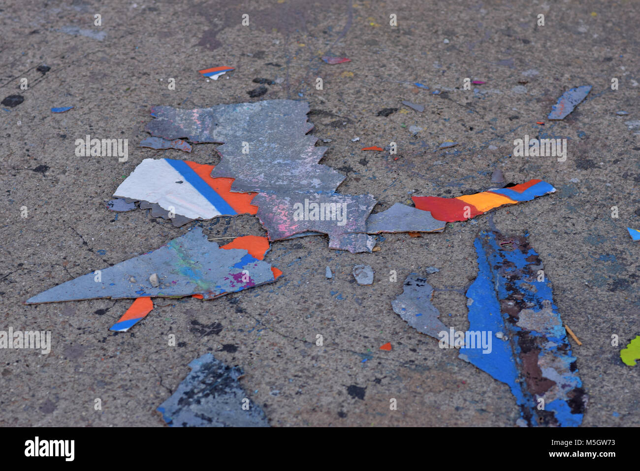 Ripped up paint flakes on the sidewalk Stock Photo - Alamy