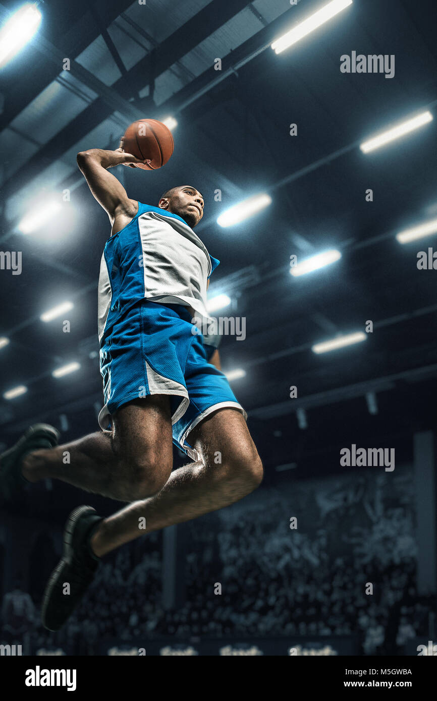 Basketball player in motion or movement on big professional arena ...