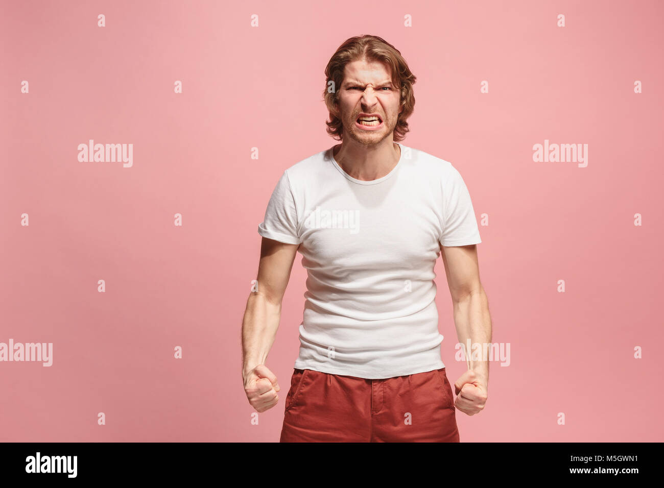 Screaming, hate, rage. Crying emotional angry man screaming on pink ...