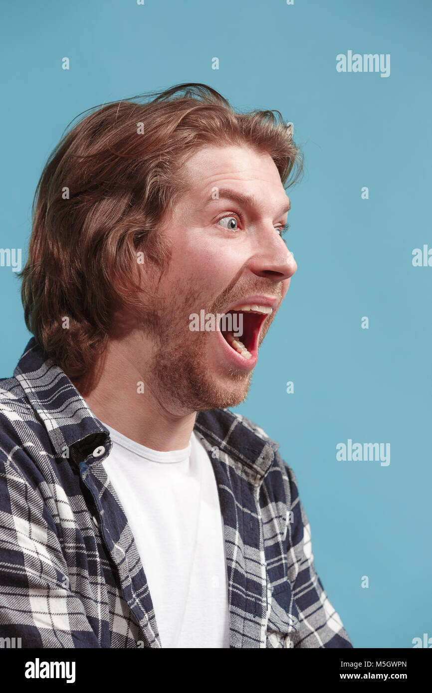 Screaming, hate, rage. Crying emotional angry man screaming on blue ...