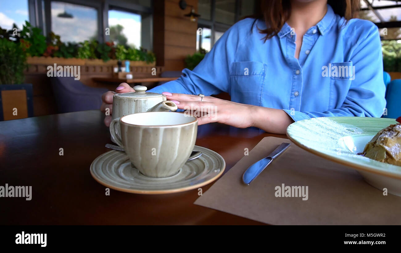 Charming restaurant customer pouring water into cup in Stock Photo - Alamy