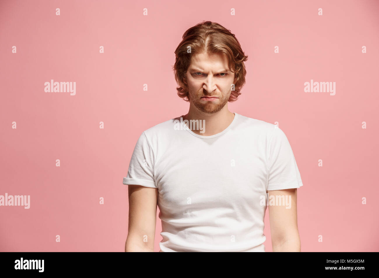 Angry man looking at camera. Aggressive business man standing isolated ...