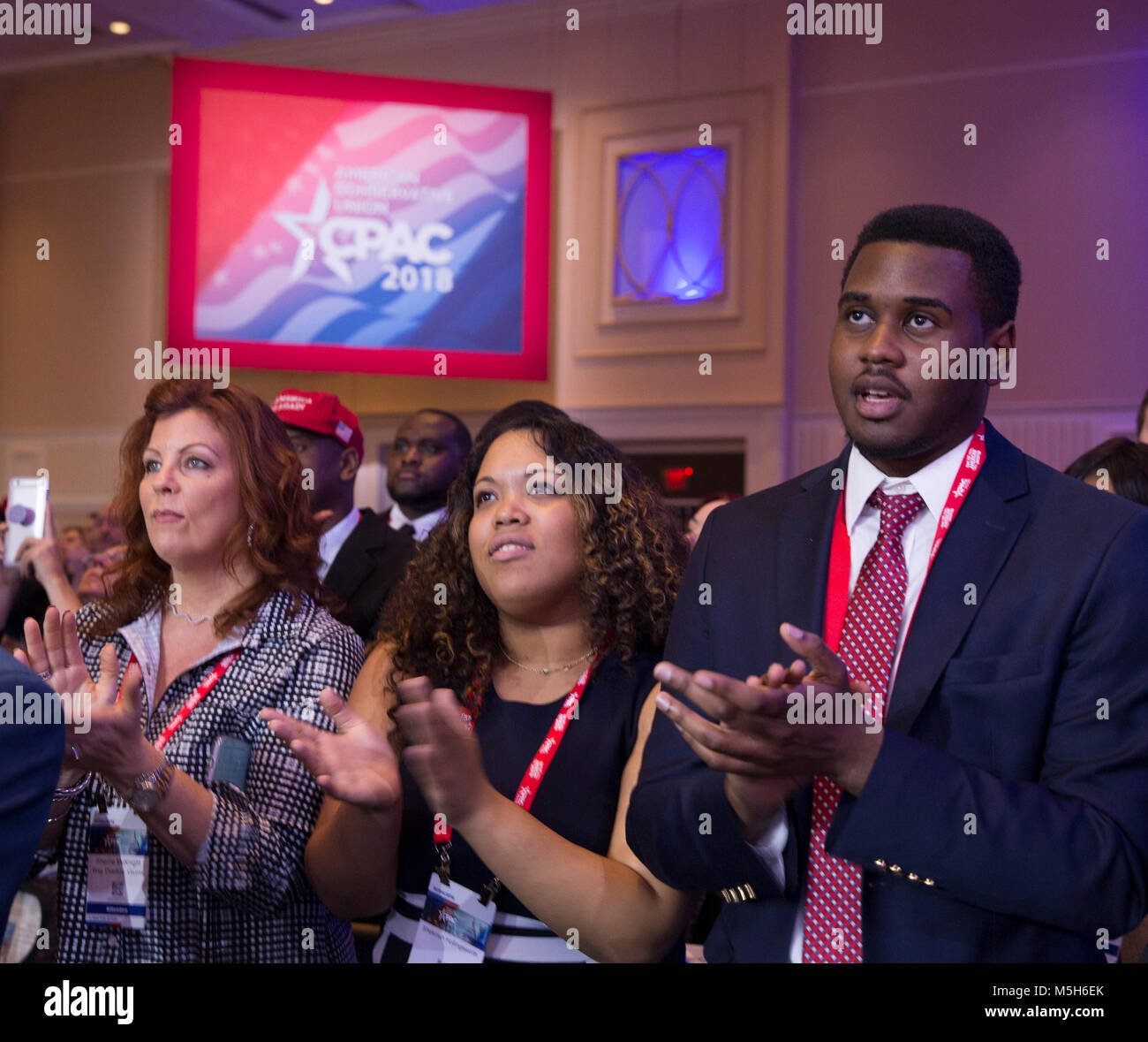 Attendees listen and applaud as United States President Donald J. Trump ...