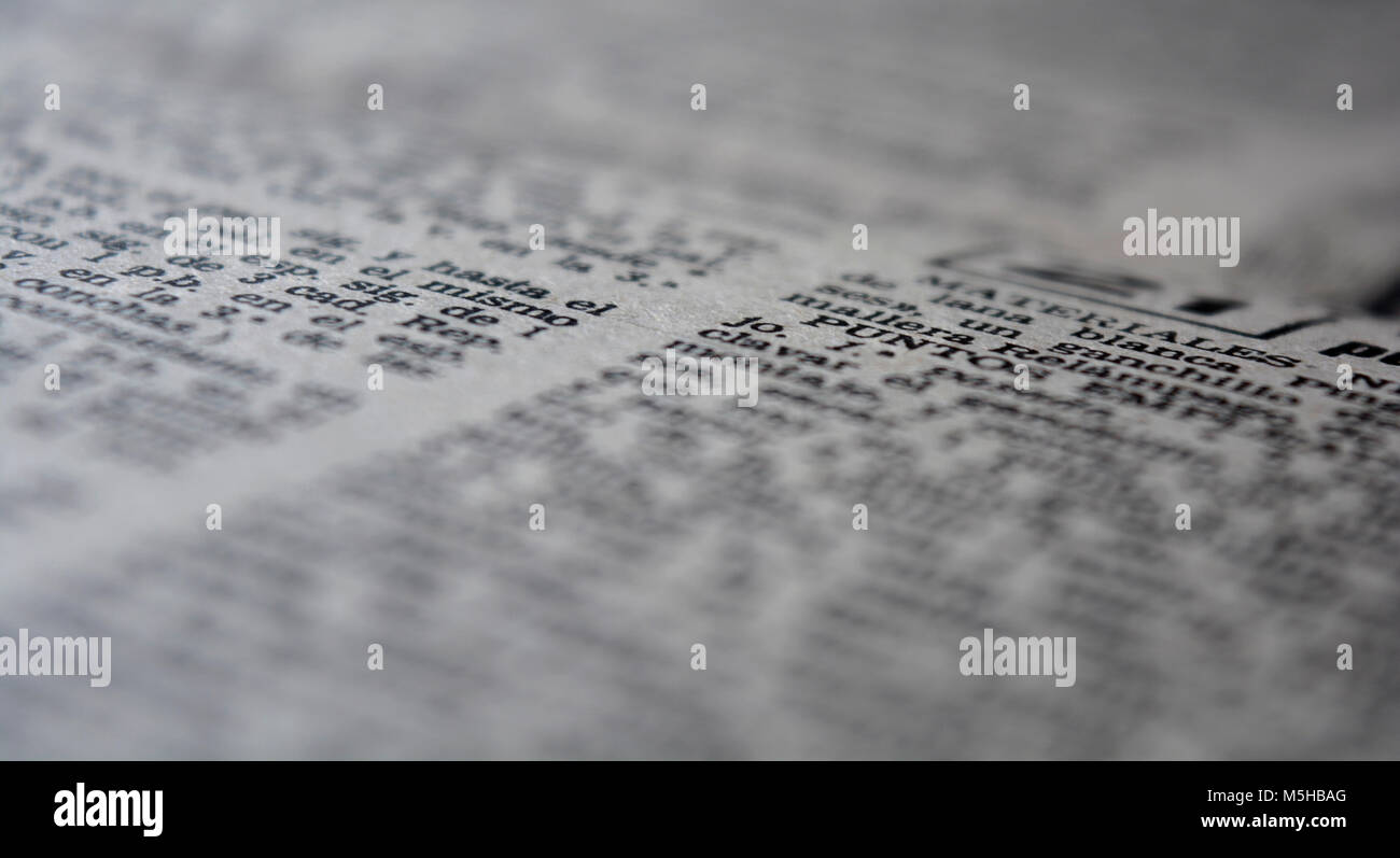 Closeup of an old magazine page of text in Spanish, text is unreadable ...