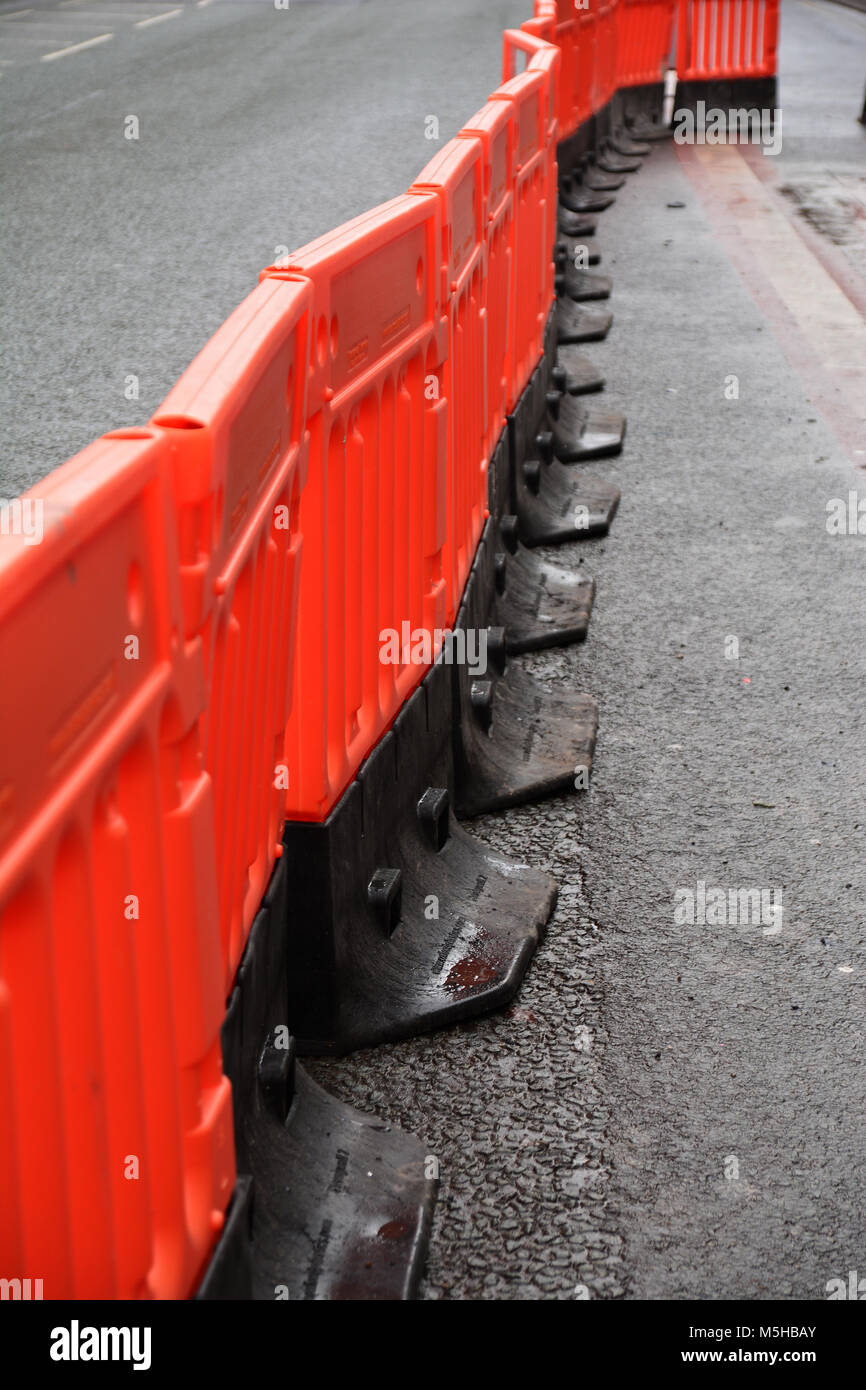 A photo of a temporary walkway with plastic safety barriers on a ...