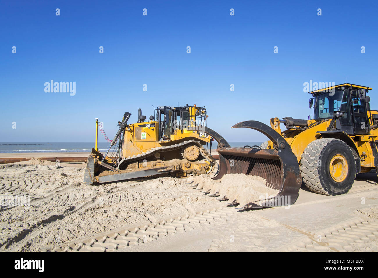 Bulldozers used for sand replenishment / beach nourishment to make ...