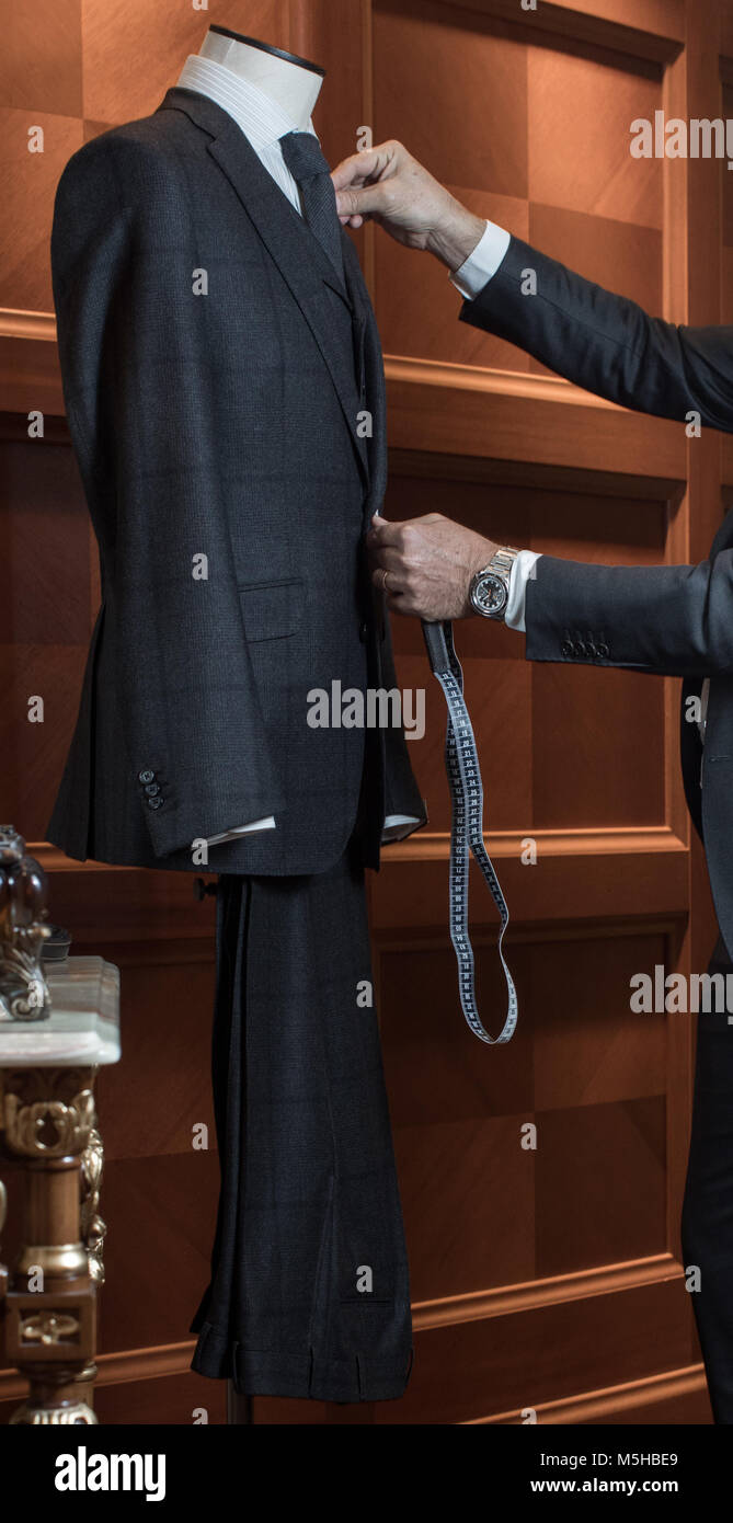 Tailor measuring suit on dummy Stock Photo - Alamy