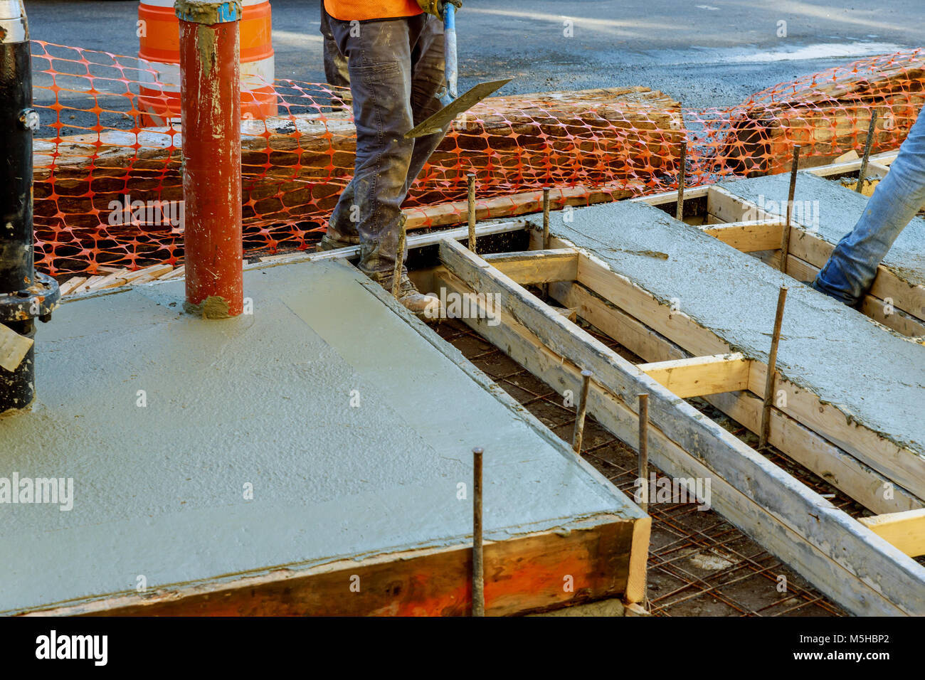 Construction worker leveling concrete pavement. Masonry construction ...