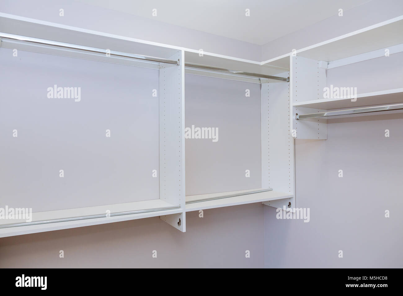 installation of shelves with a shelf near of big cabinet. Furniture ...