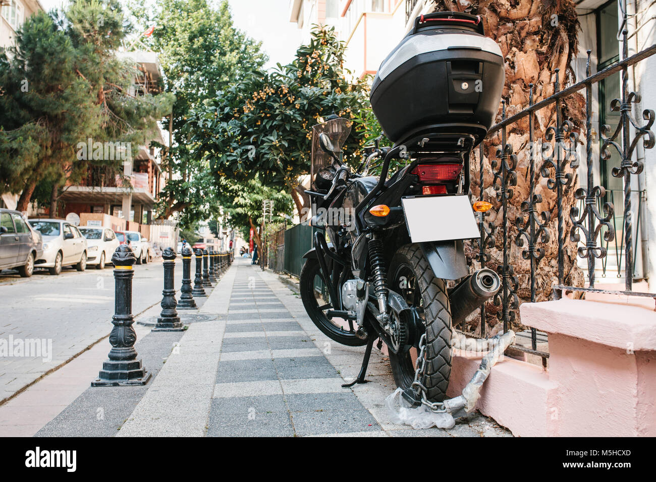 The motorcycle is parked on the street and closed to a special lock ...